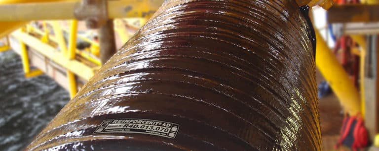 Composite wrapping for piping systems and pipe reinforcement